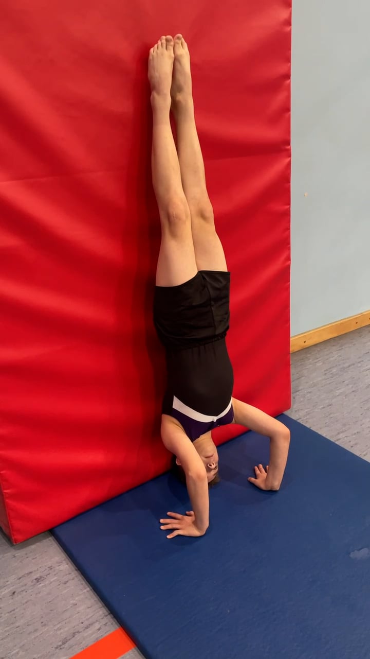 headstand-with-straight-legs-using-mat-against-the-wall-hold-for-5