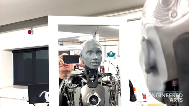 Ameca Robot Looks at Herself in a Mirror and Likes What She Sees