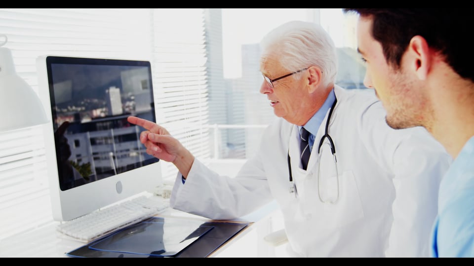 Animation of glowing lights over caucasian male doctors with computer ...