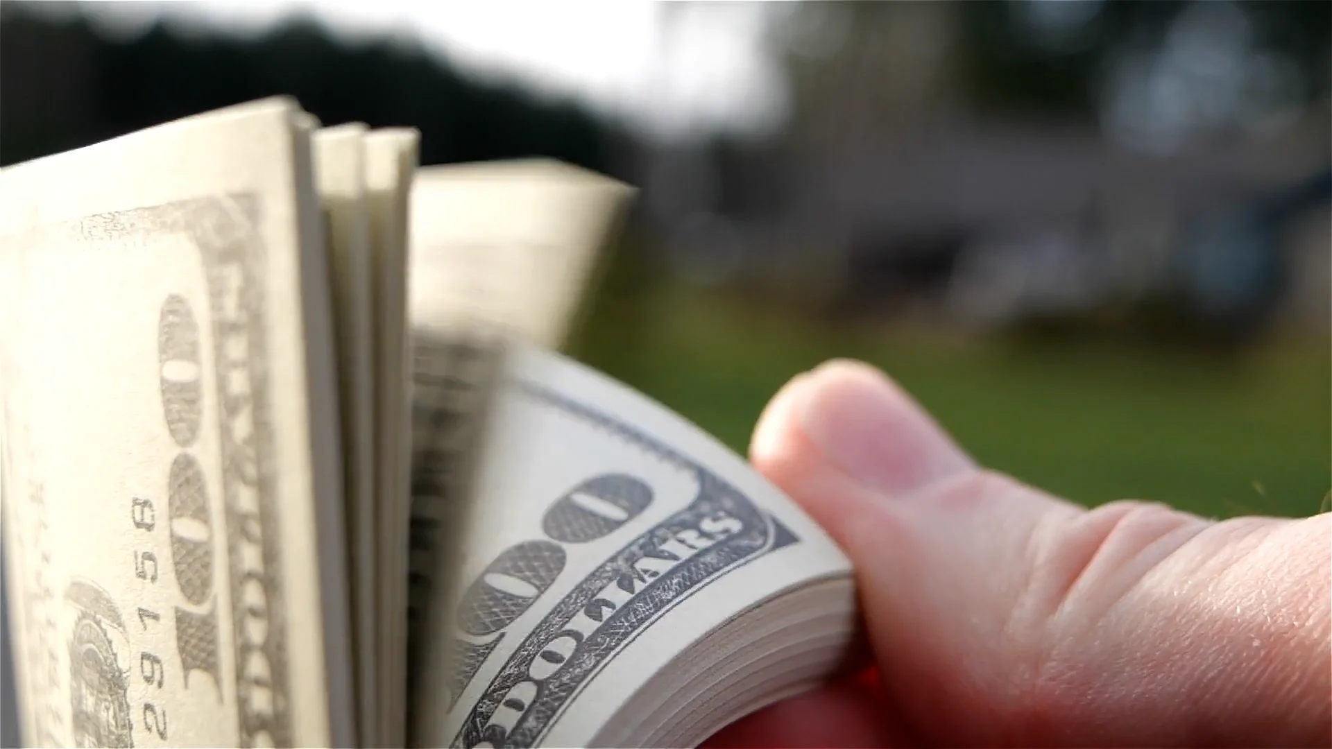 close-up-of-a-male-hand-flipping-through-a-stack-of-100-dollar-bills ...