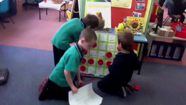 Students using talking tin lids to support writing. on Vimeo