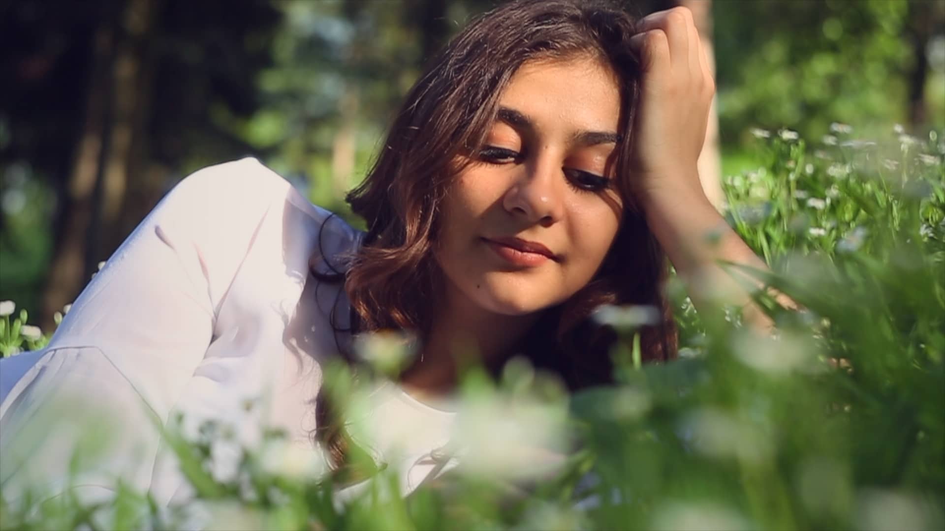 075379988-beautiful-happy-girl-lying-gra on Vimeo