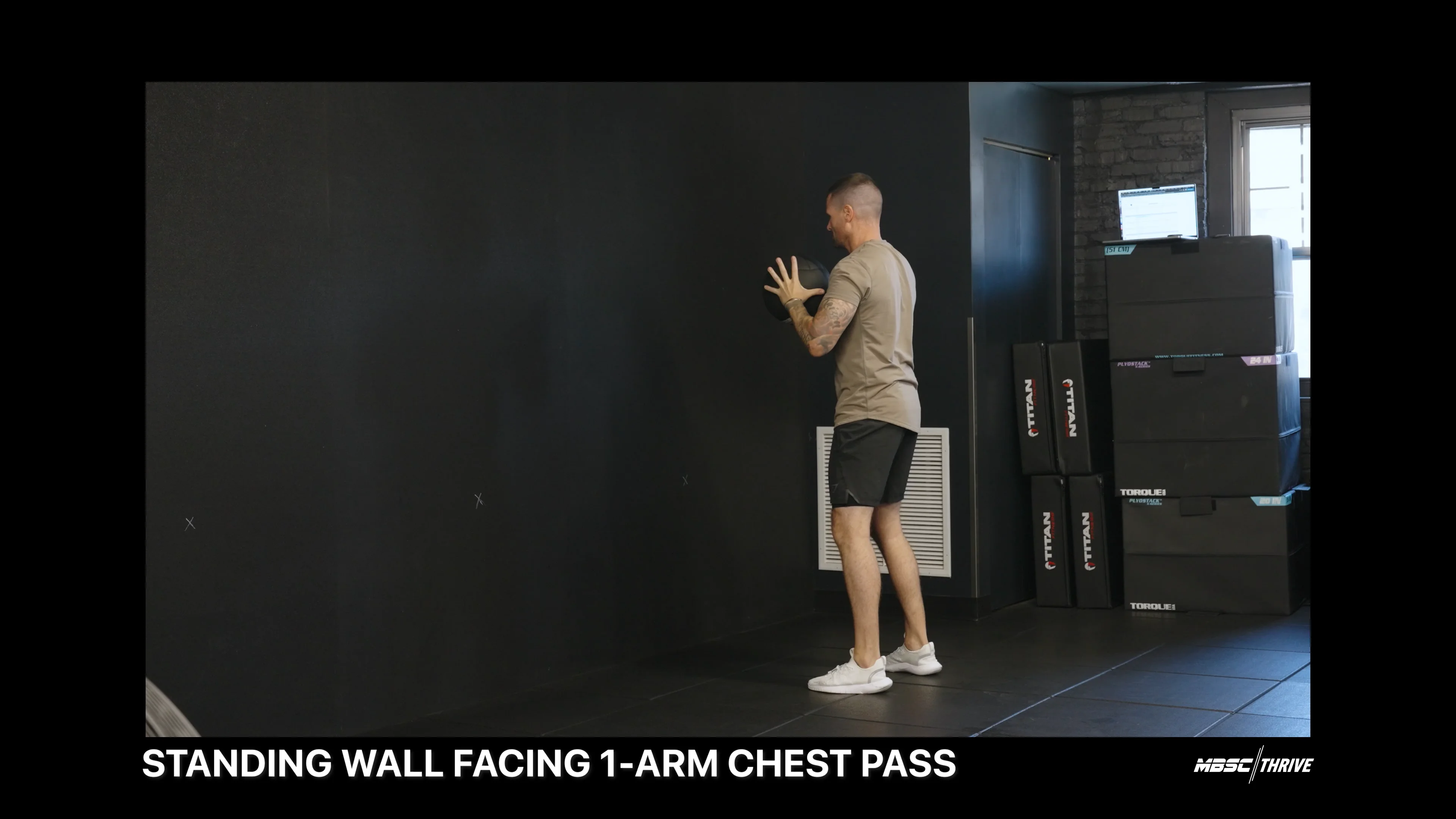 STANDING WALL FACING 1-ARM CHEST PASS