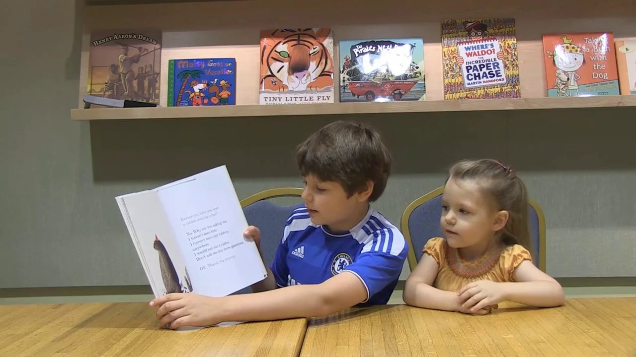 John Henry and Ravelle read a picture book