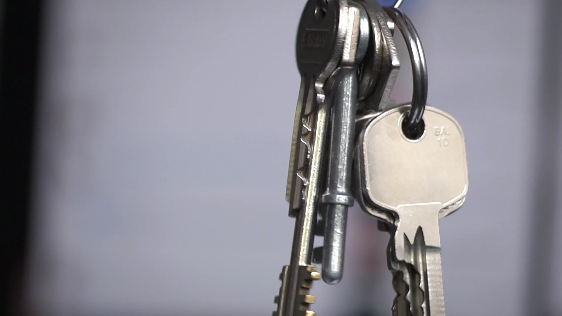 Janitor holds and wiggles key chains, rings and cases. Slow motion HD ...