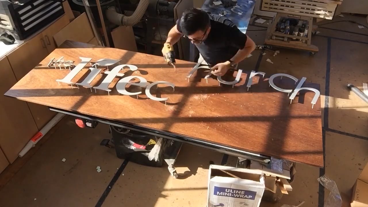 Assembling a raised metal sign on Vimeo