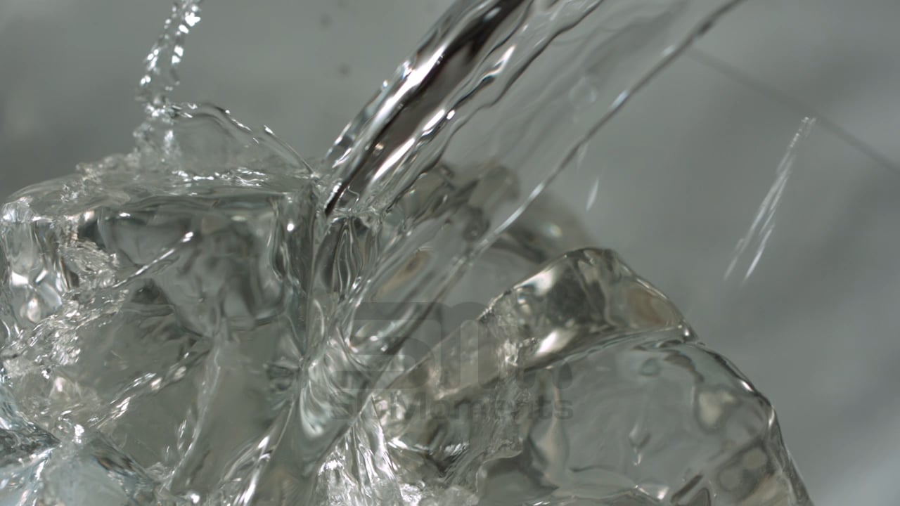 Water pouring over ice cubes on Vimeo