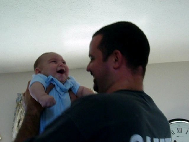 Daddy blowing raspberries on Joshua's tummy on Vimeo