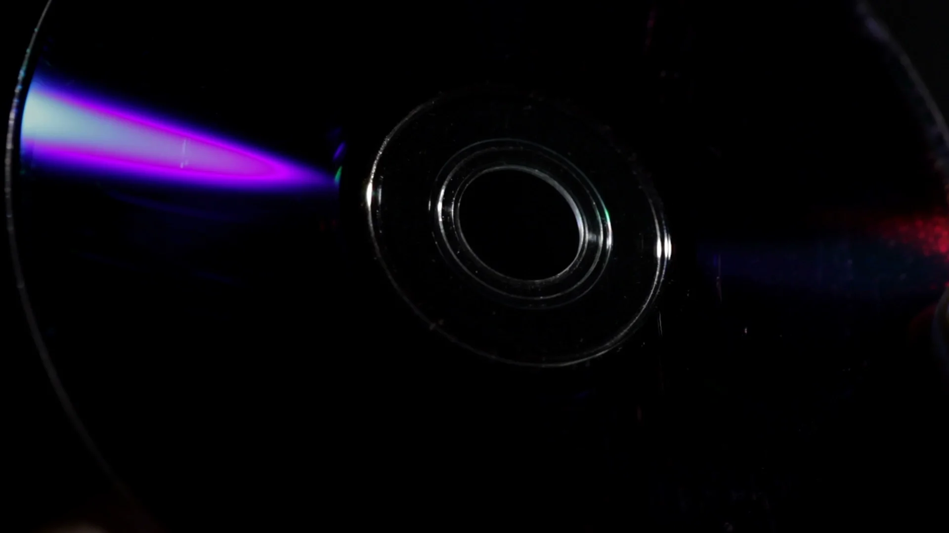 refraction-of-light-compact-disk-rotates-in-hand-on-a-black-background ...