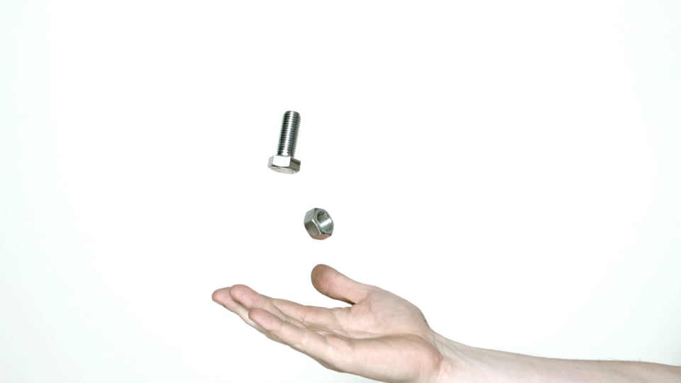 Mans hand tossing screw and bolt Video from Pikwizard