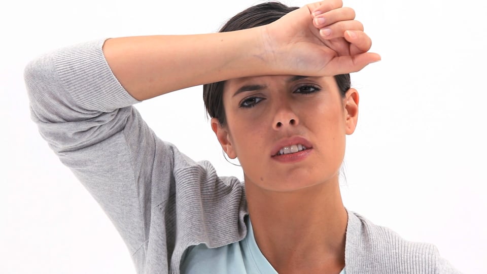 Sick woman placing her hand on her forehead Video from Pikwizard