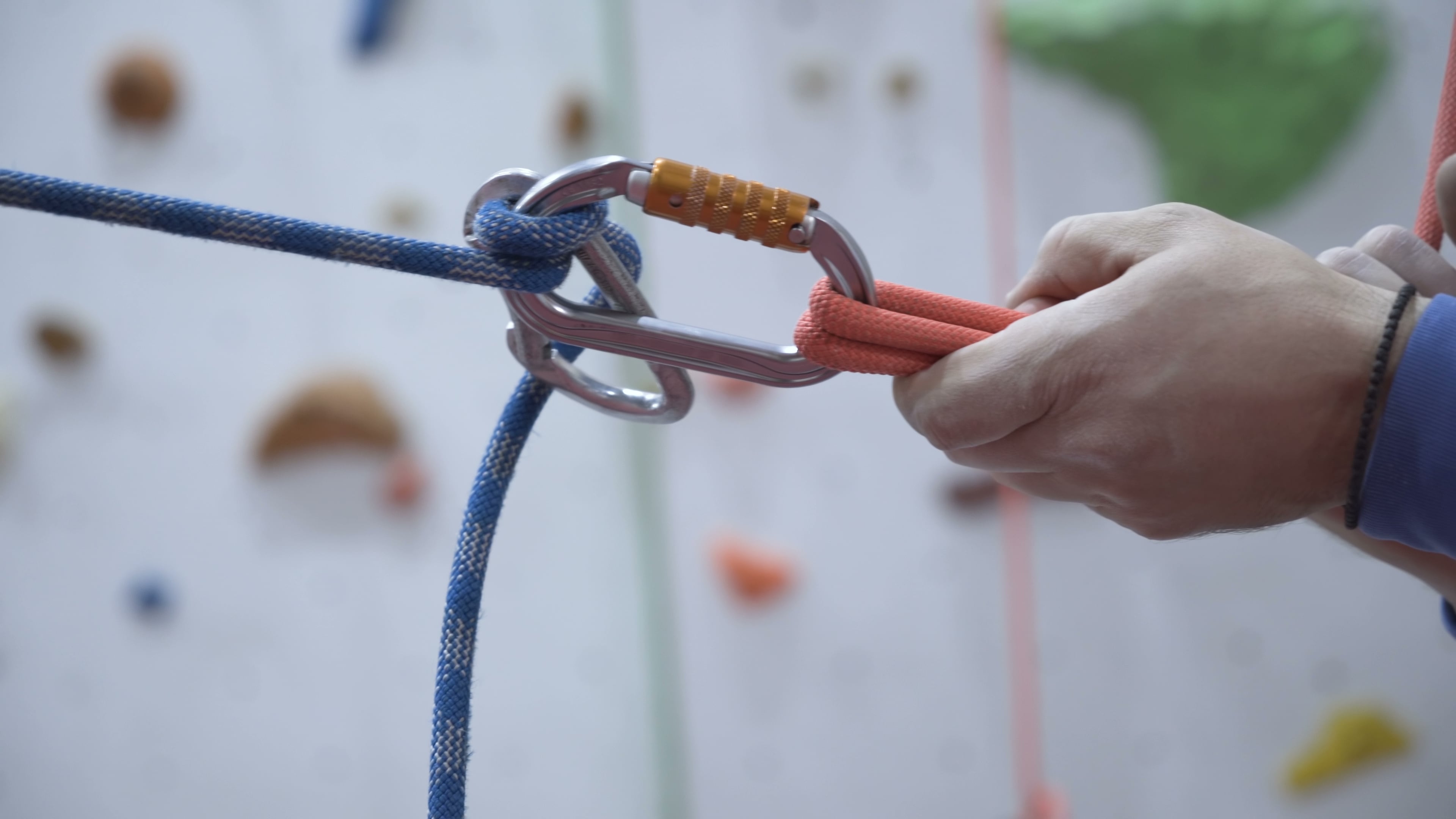 climber-setting-rope-belay-line-with-karabiner-for-EGM6K6Y on Vimeo