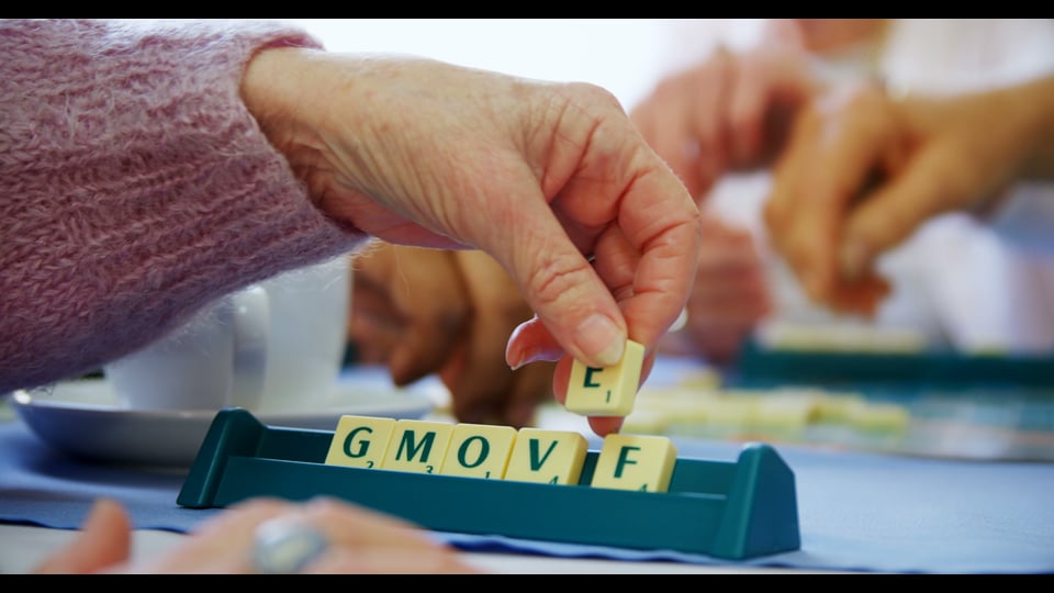Group of senior friends playing scrabble word game at nursing home 4k ...