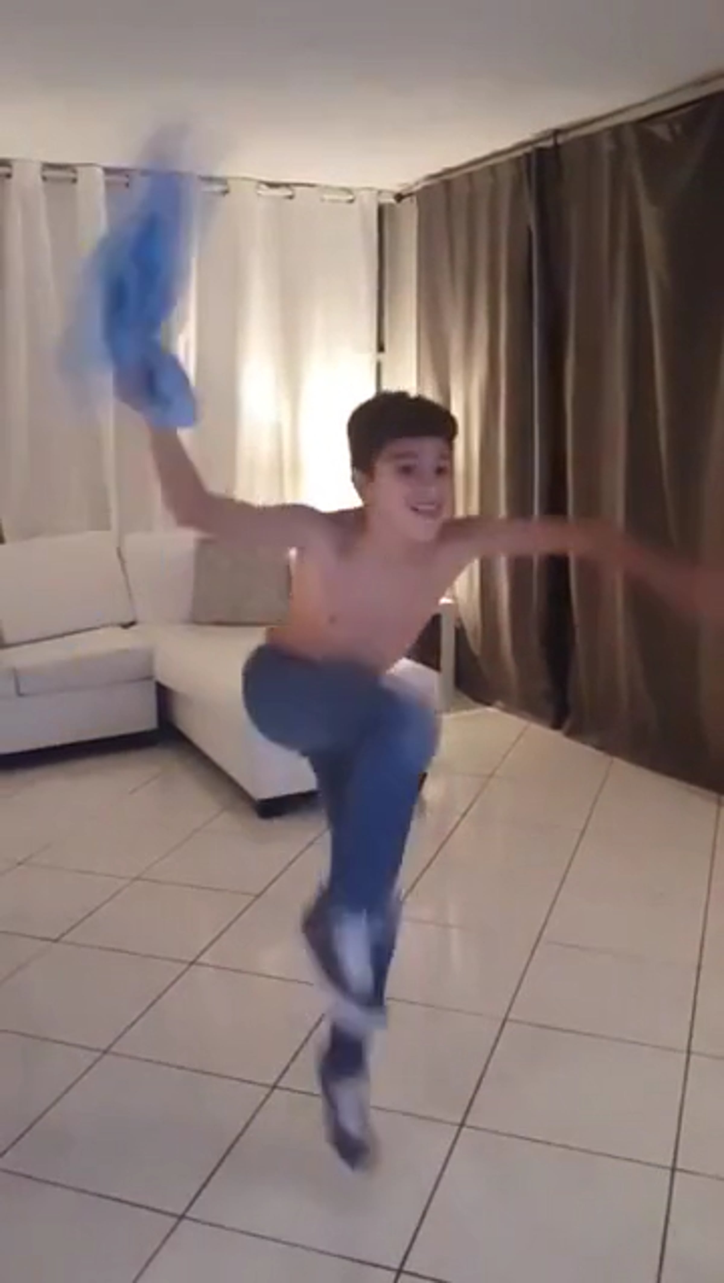 Shirtless boy in jeans dancing to timber